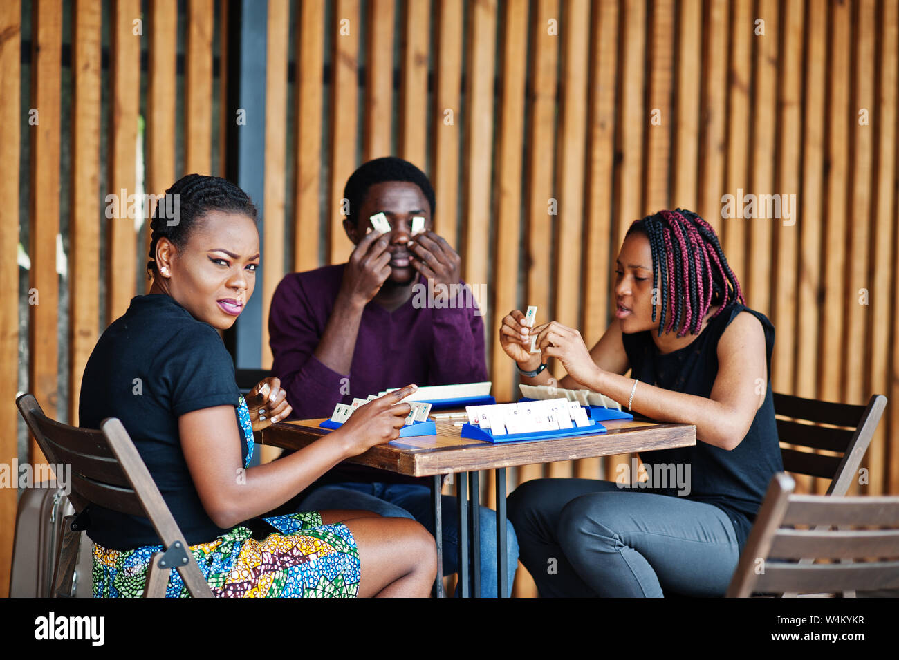 Group of three african american friends play table games Stock Photo ...