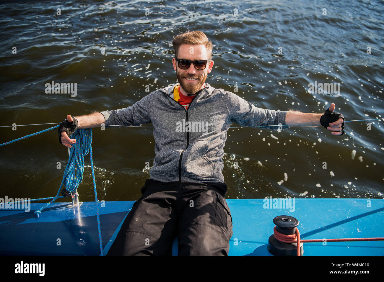 Sailing, tourism, travel and people concept - happy young man in ...