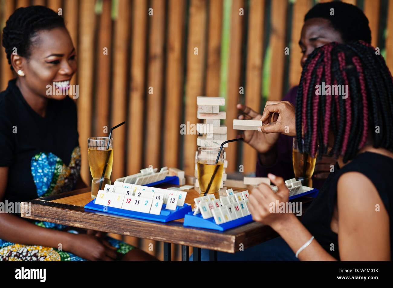 Group of three african american friends play table games Stock Photo ...