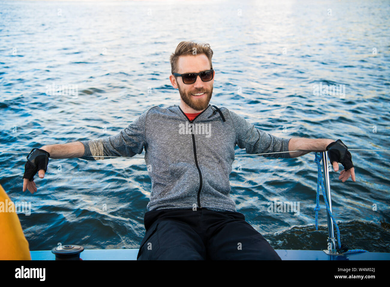 Sailing, tourism, travel and people concept - happy young man in ...