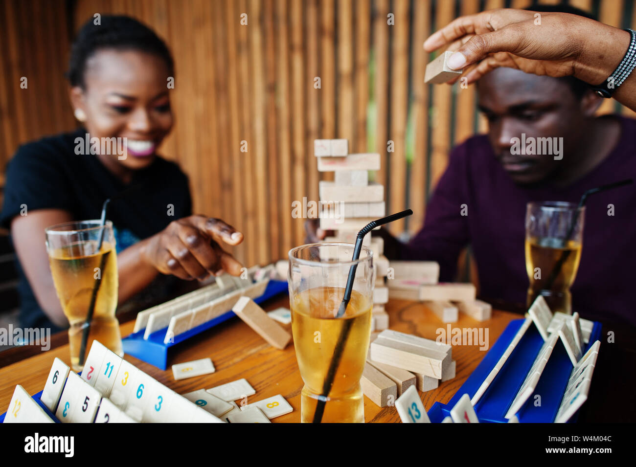 Group of three african american friends play table games Stock Photo ...
