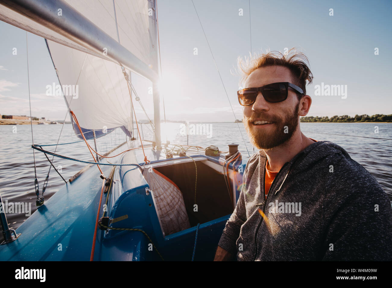 Adult man on marina sport boat portrait happy relaxed on a sunset Stock ...