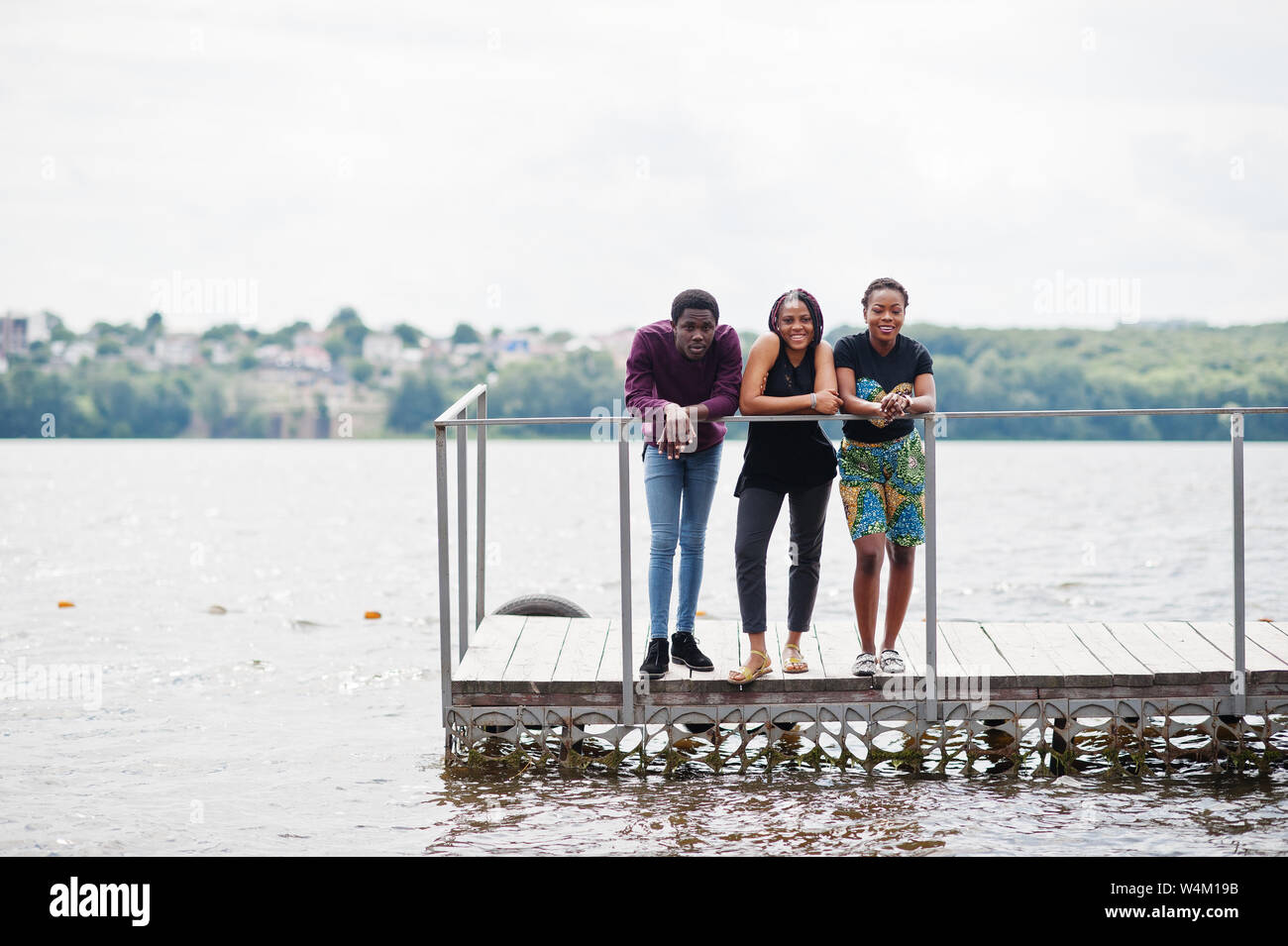 Three african american friends posed on pier Stock Photo - Alamy