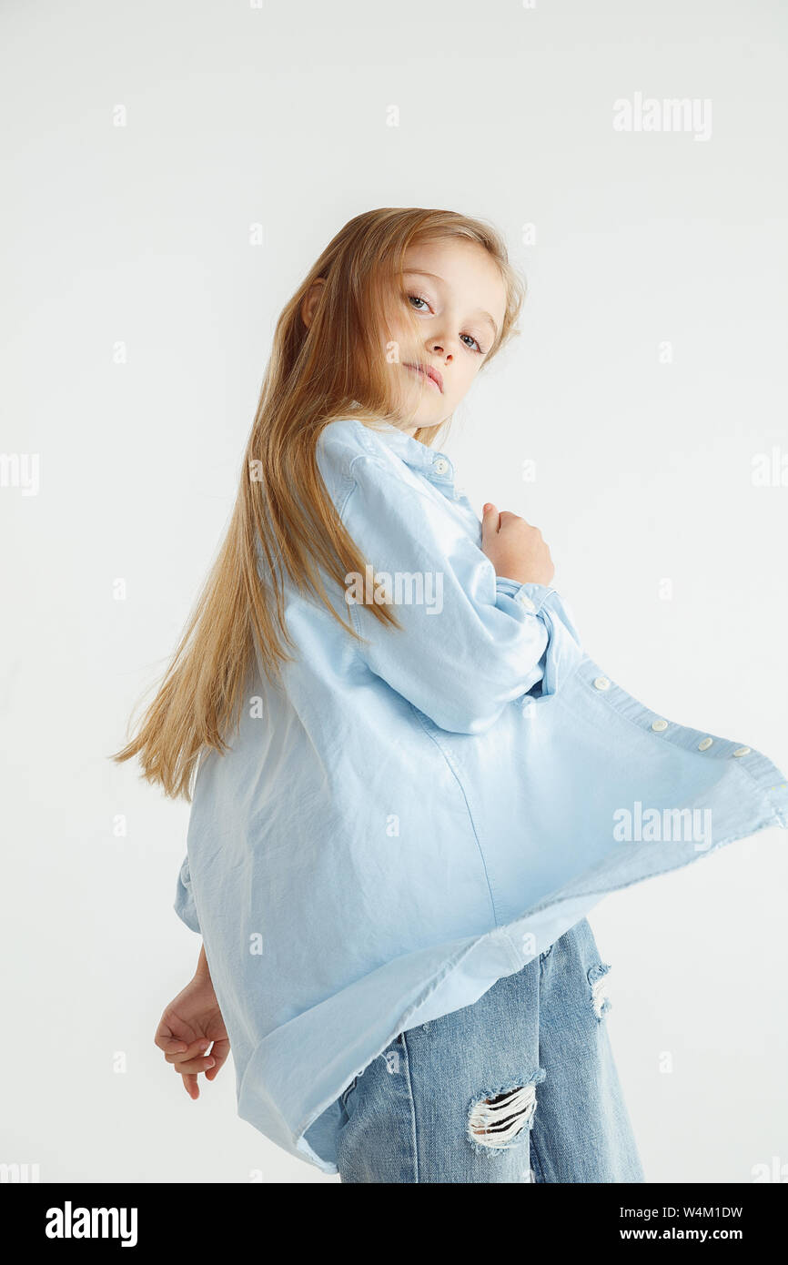 Stylish little smiling girl posing in casual clothes isolated on white ...