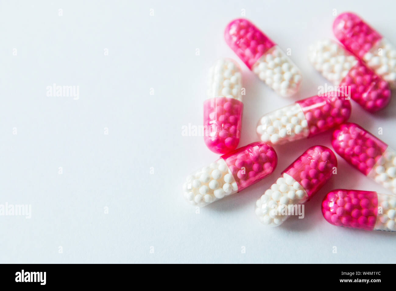 pink capsules isolated on white background, copyspace for text ...