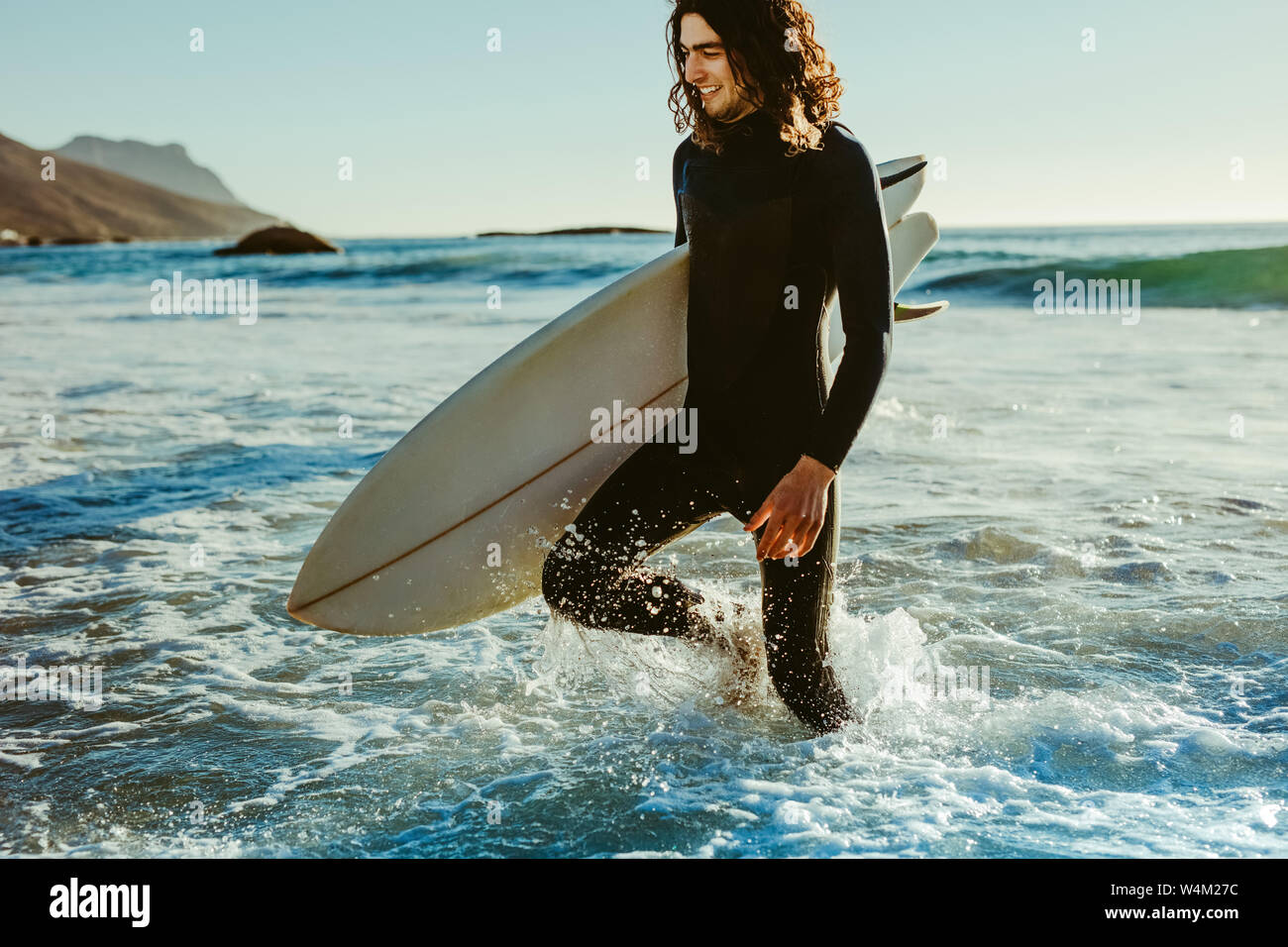 Young surfer coming out of the water on the beach hi-res stock ...
