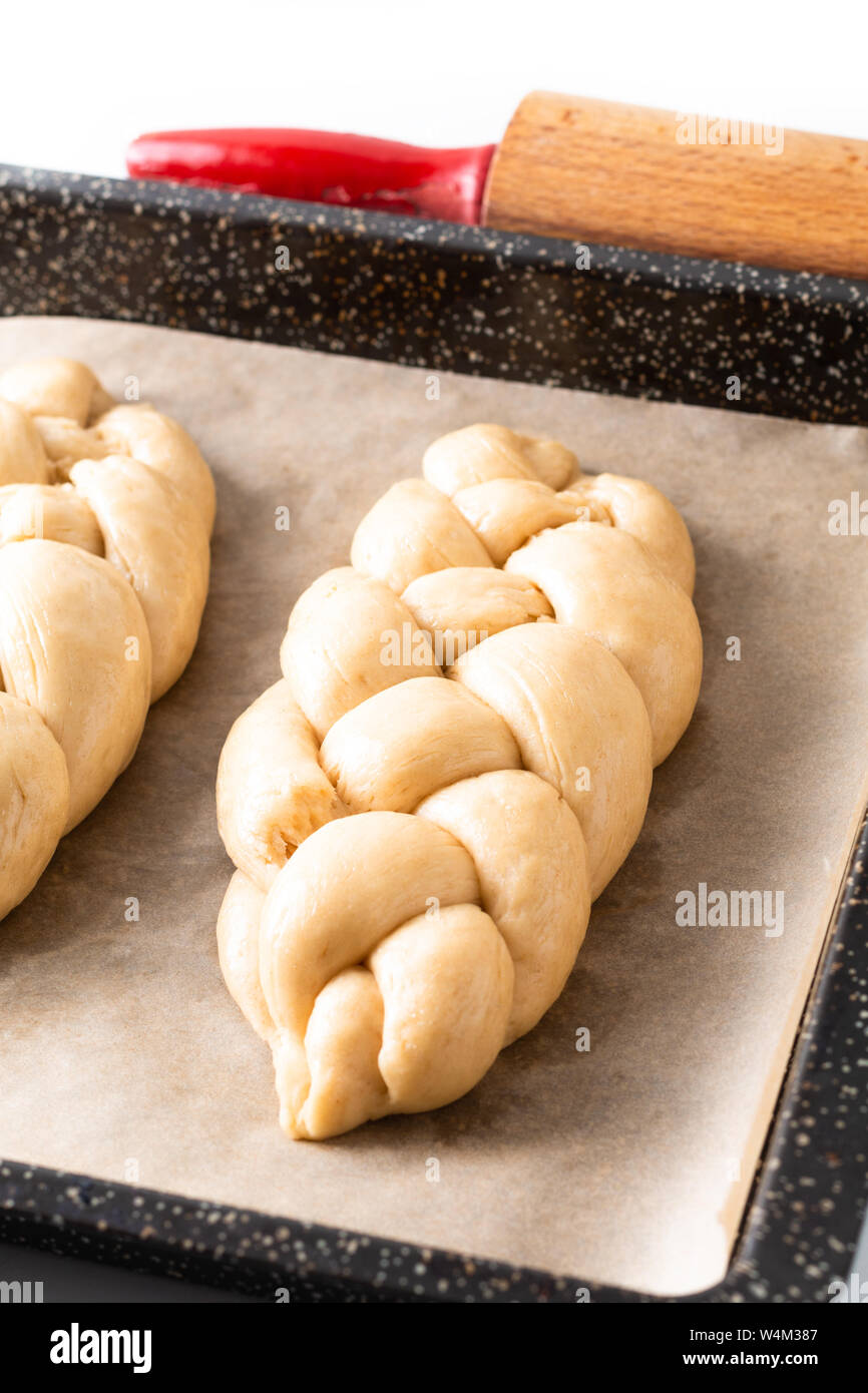 Homemade food concept process proved bread braid challah dough on white ...