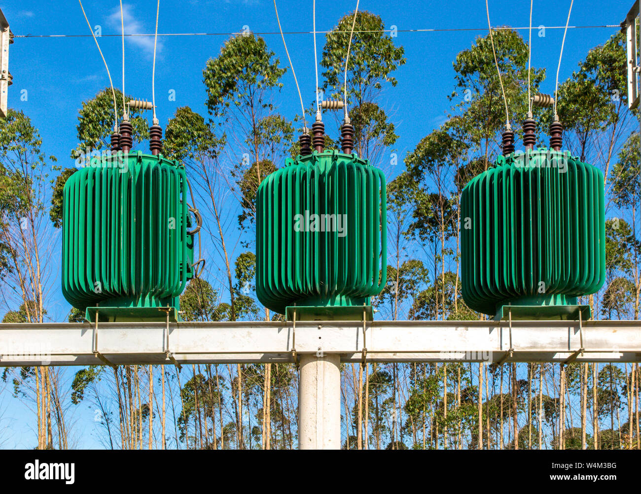 Three green energy transformers in concrete electrical structure, with ...