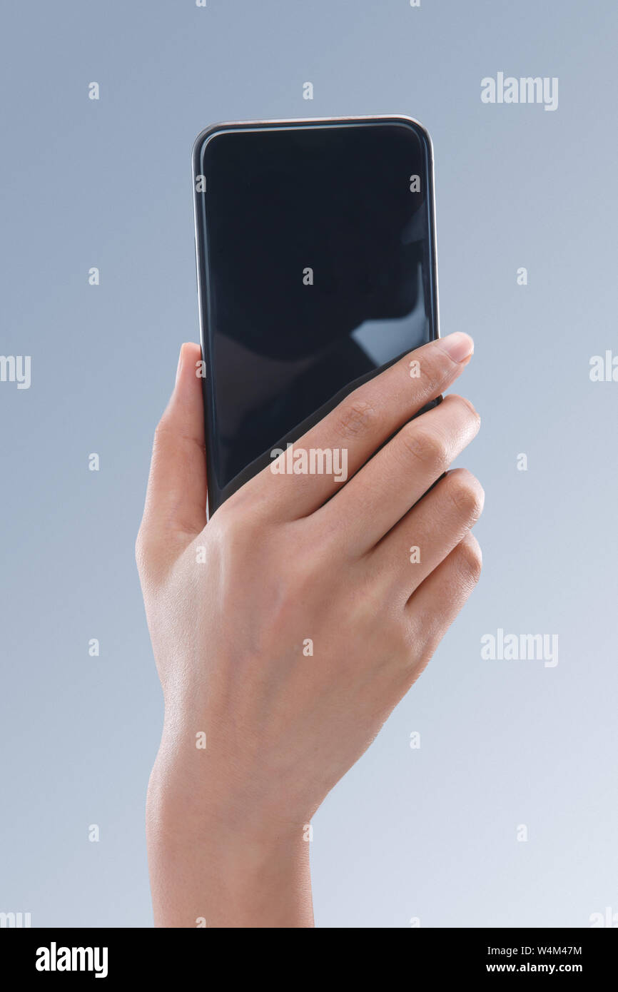 Holding a mobile phone Stock Photo - Alamy