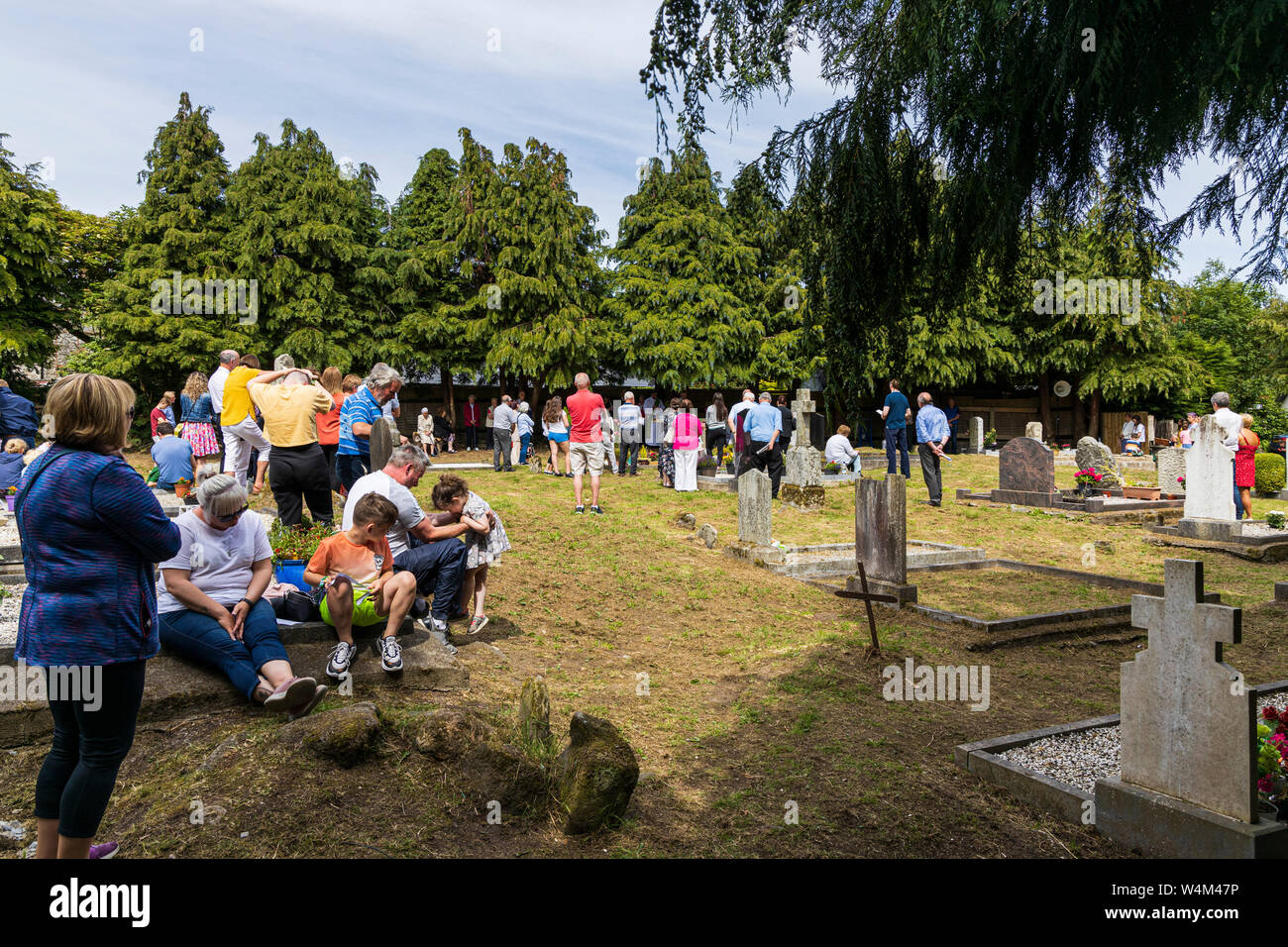 Outdoor mass in Templeboden cemetery, amongst the gravestones on a July ...