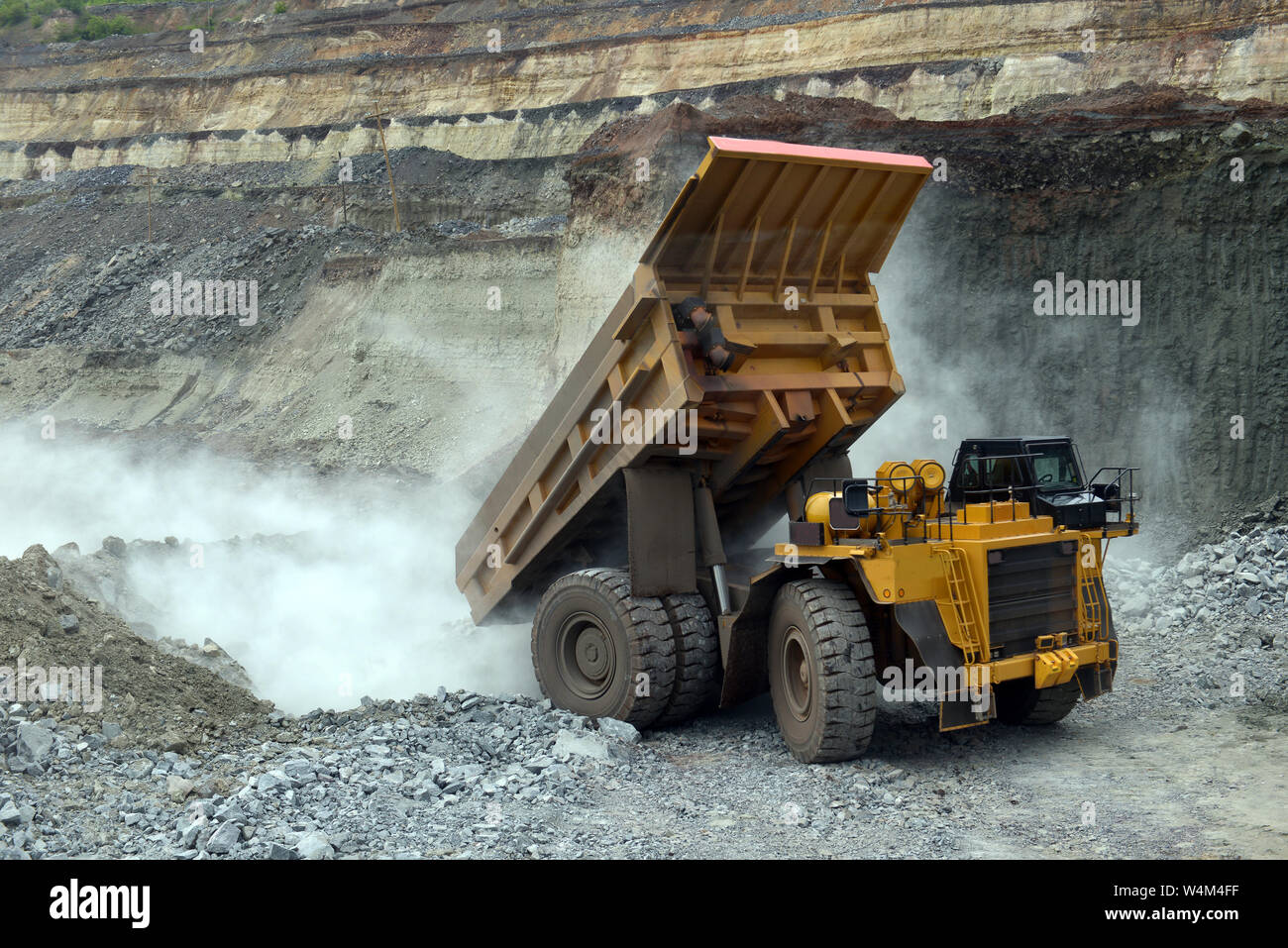 large mining loader unloads extracted ore or rock. View from the back ...