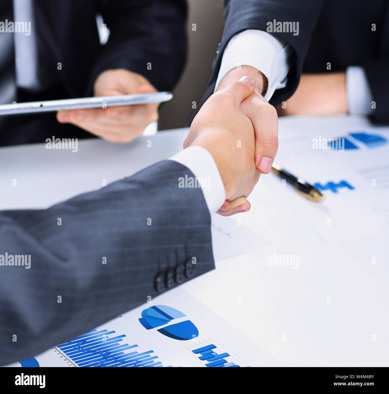 Photo of handshake of business partners after signing promising ...