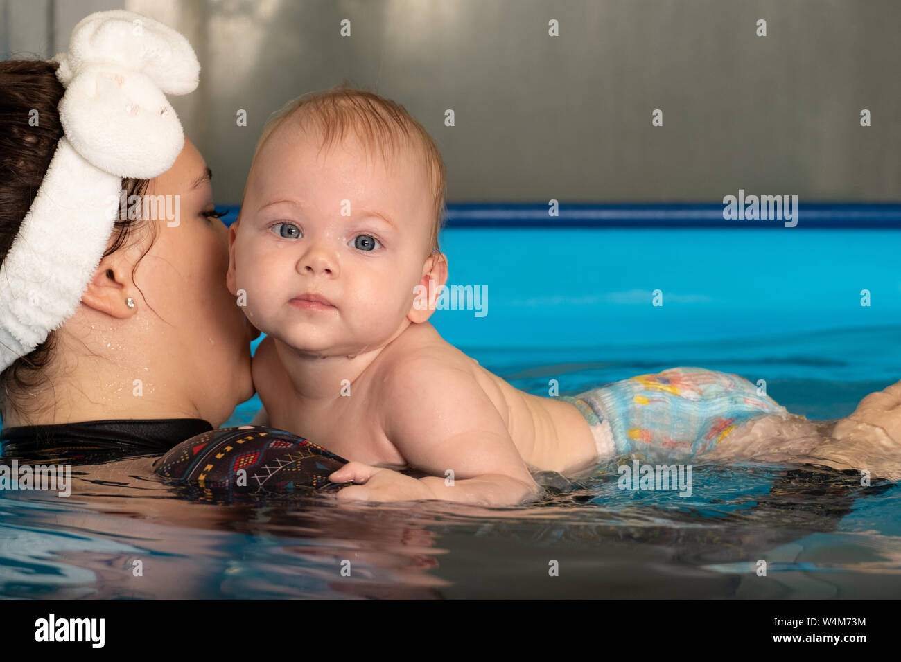 Infant swimming. Baby girl swimming in a pool Stock Photo - Alamy Infant swimming. Baby girl swimming in a pool Stock Photo - Alamy