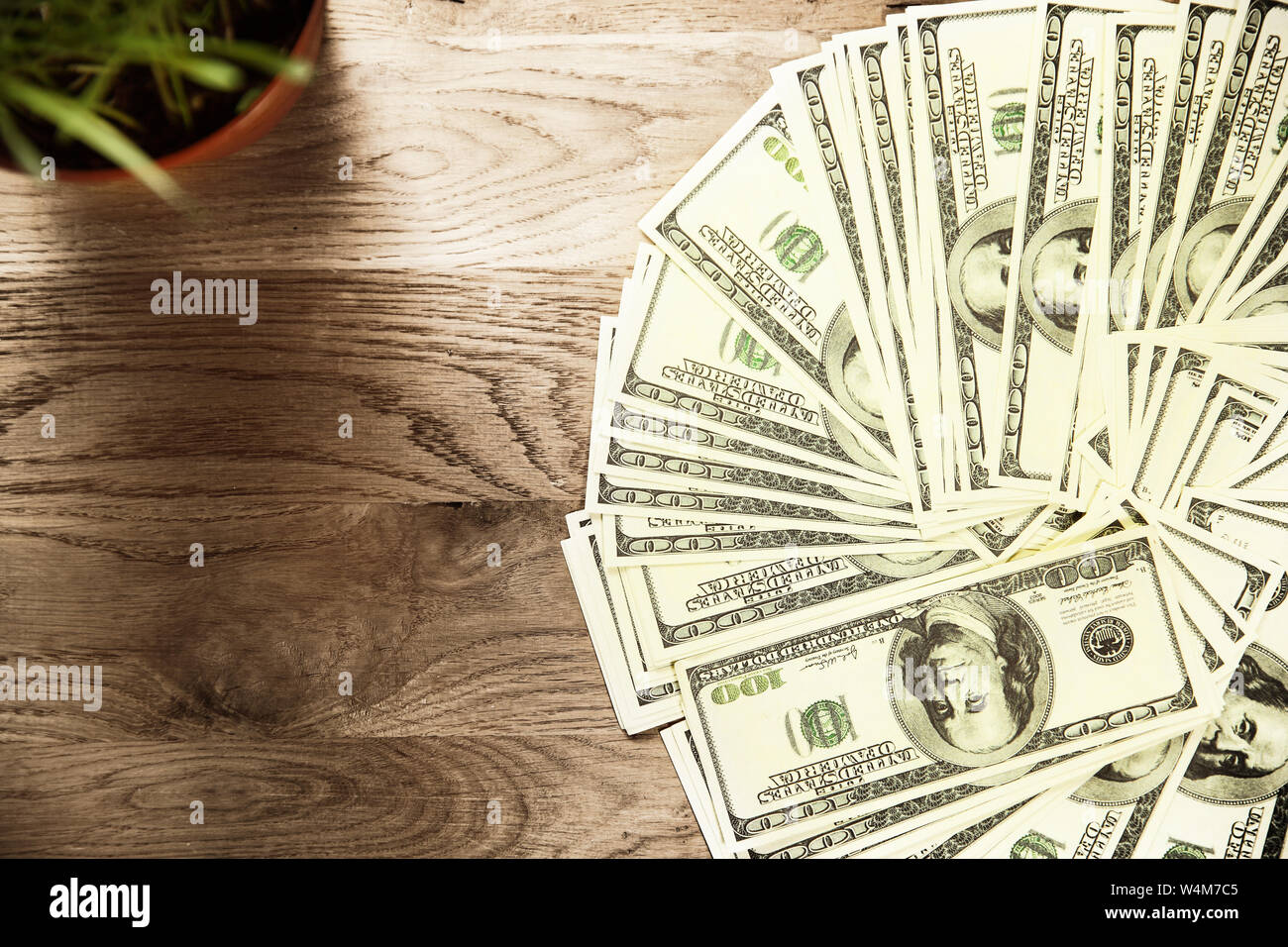 Photo banknotes US dollars on wooden background, on the left there is a ...