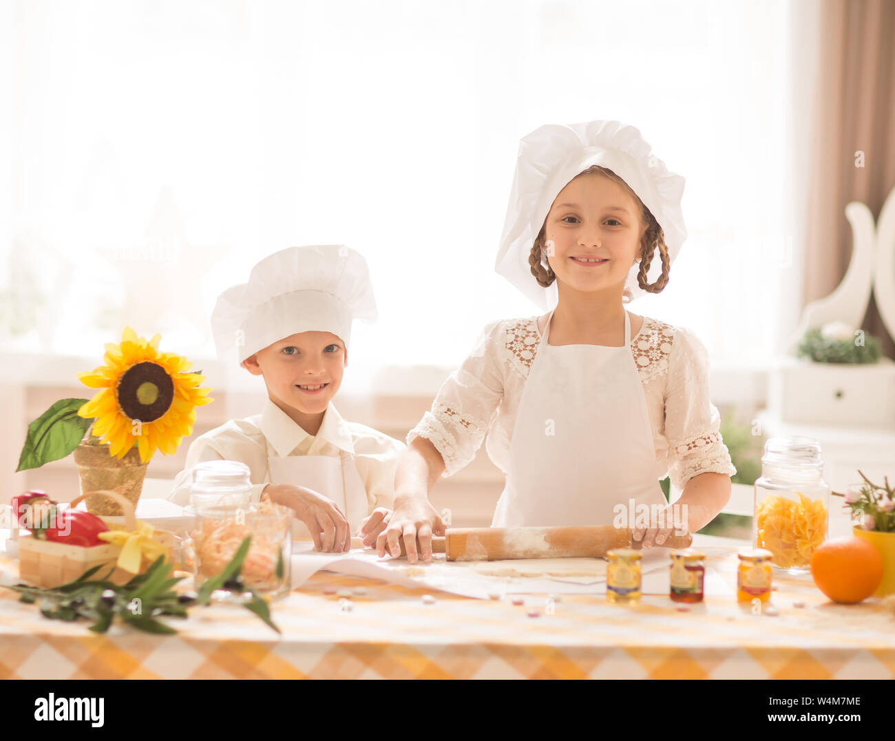 happy little children in the form of a chef to cook a delicious dinner ...