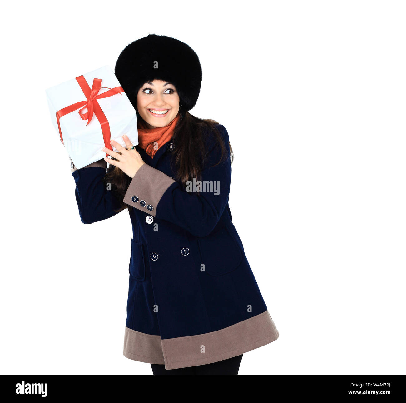 Beautiful woman with a gift in the hands, trying to guess what's in the ...