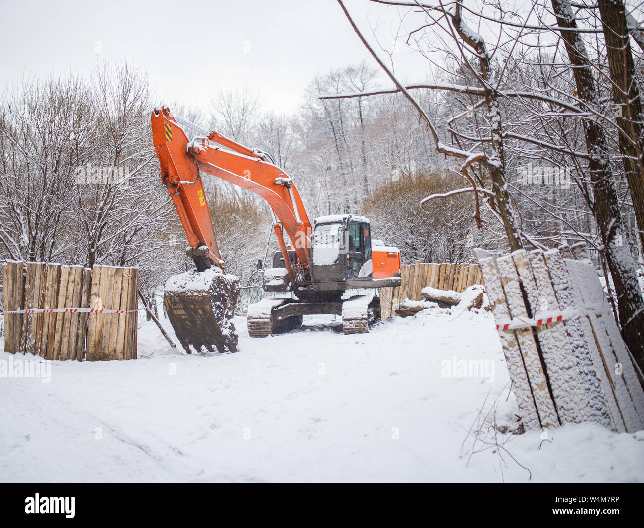 Photo of working excavator in winter day Stock Photo - Alamy