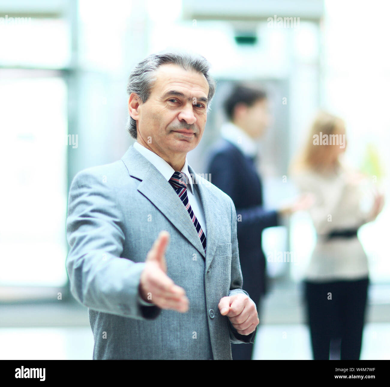 Welcoming business man ready to handshake with hand extended Stock ...