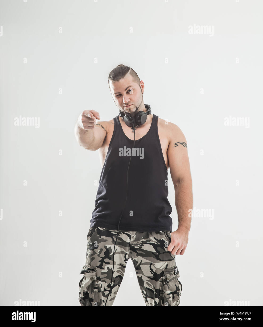 charismatic DJ - rapper with headphones on a white background.the photo ...