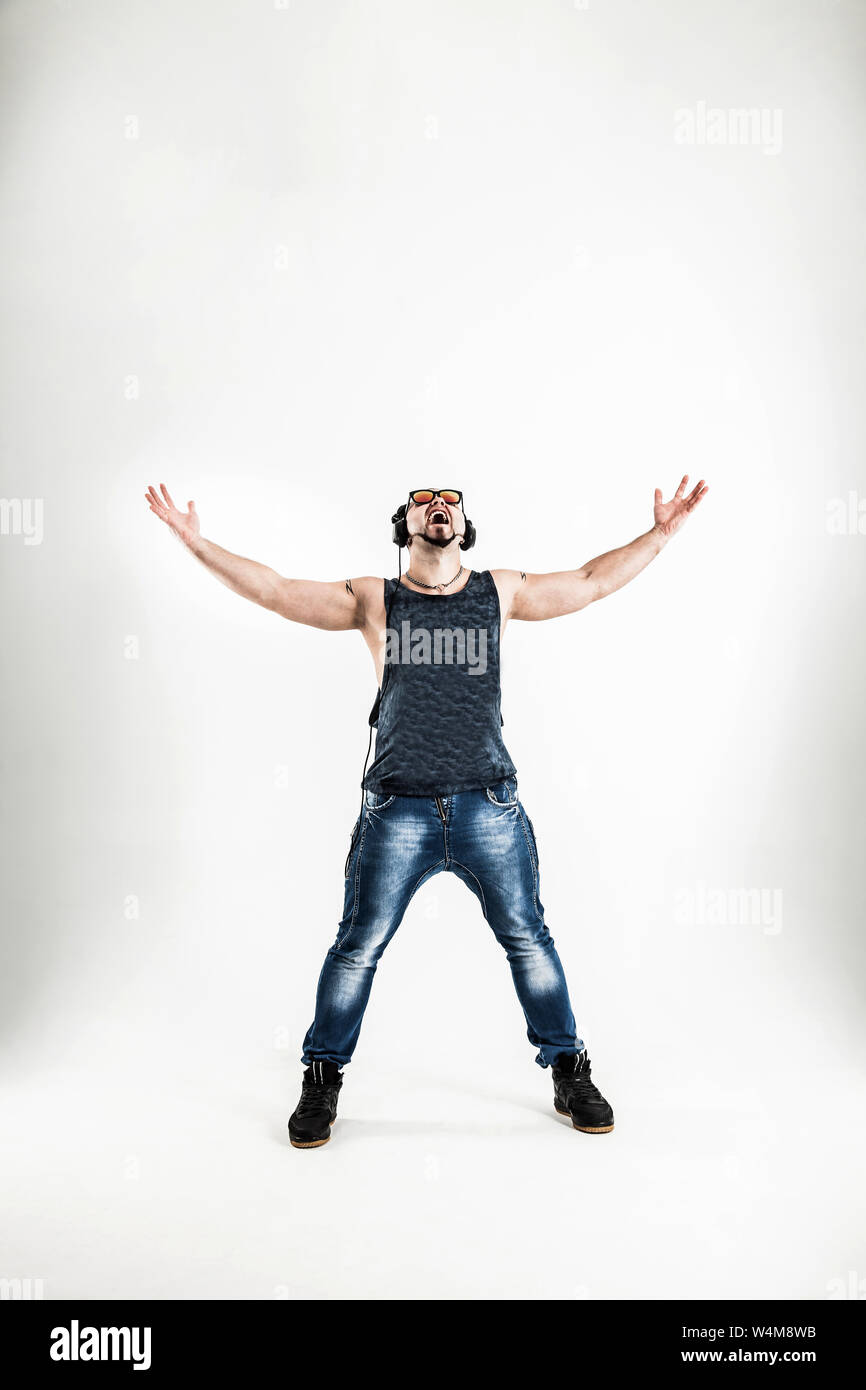 charismatic DJ - rapper with headphones on a light background.the photo ...