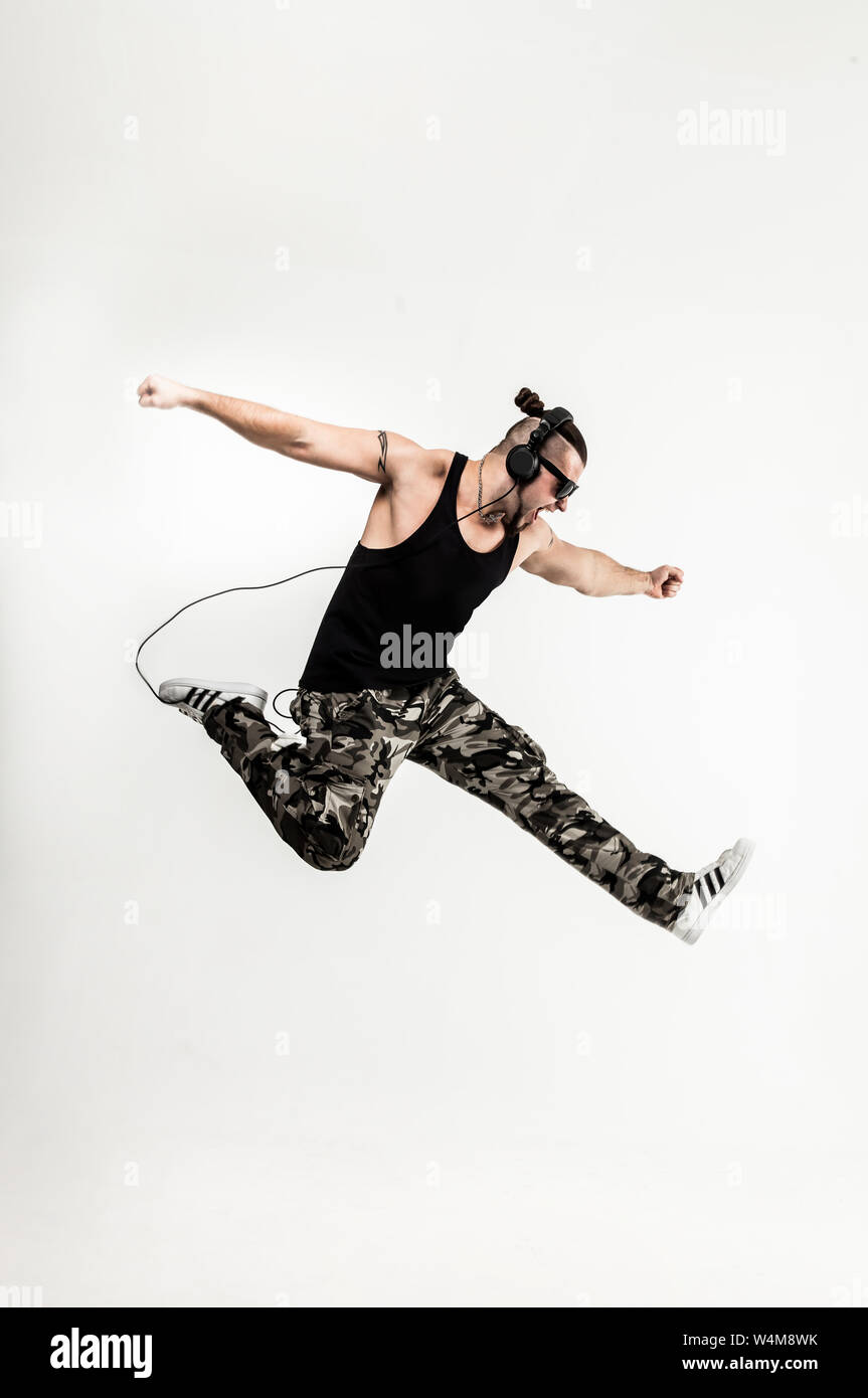 charismatic DJ - rapper with headphones on a white background.the photo ...