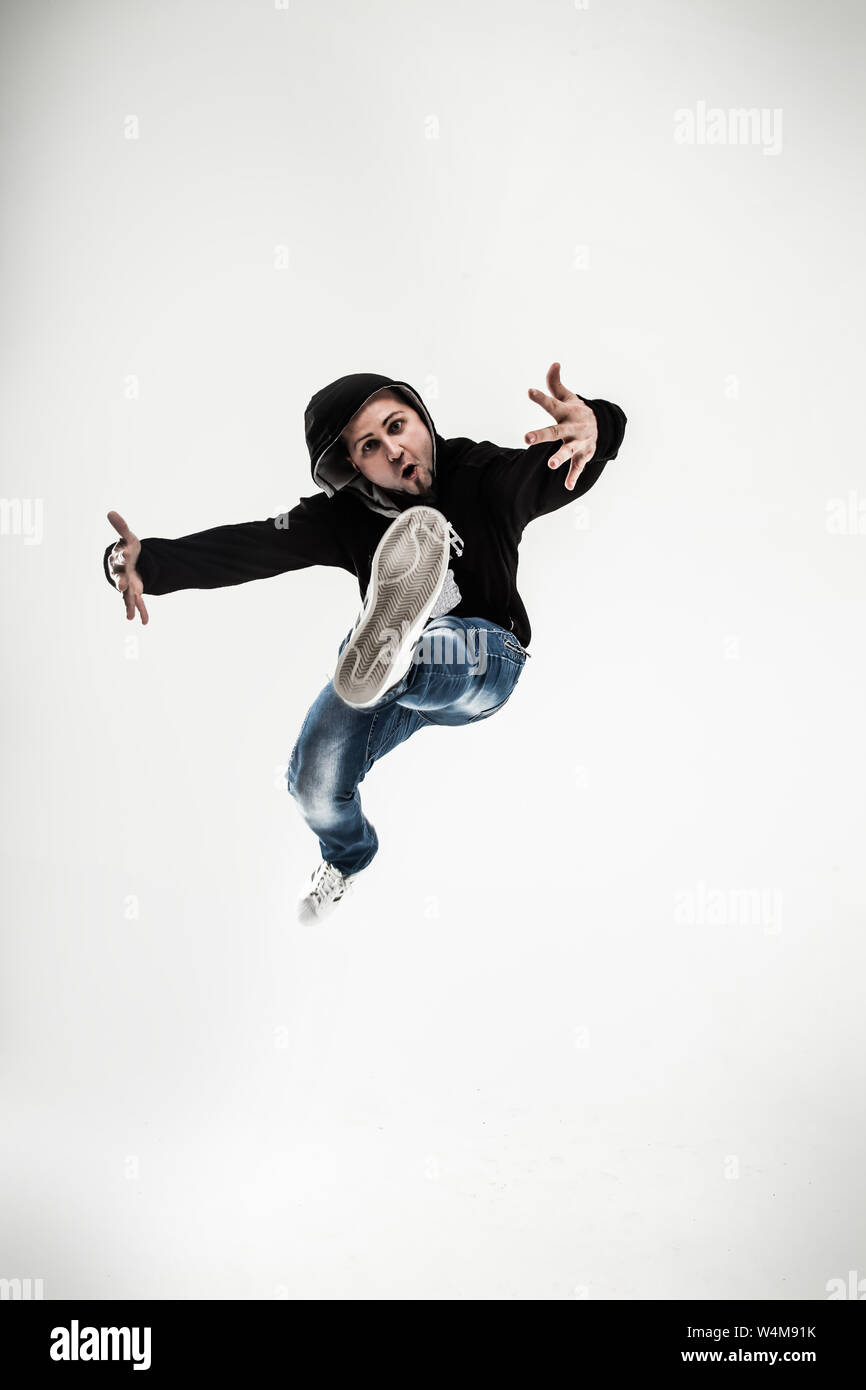 stylish rapper is dancing breakdance .photo on a white background.the ...