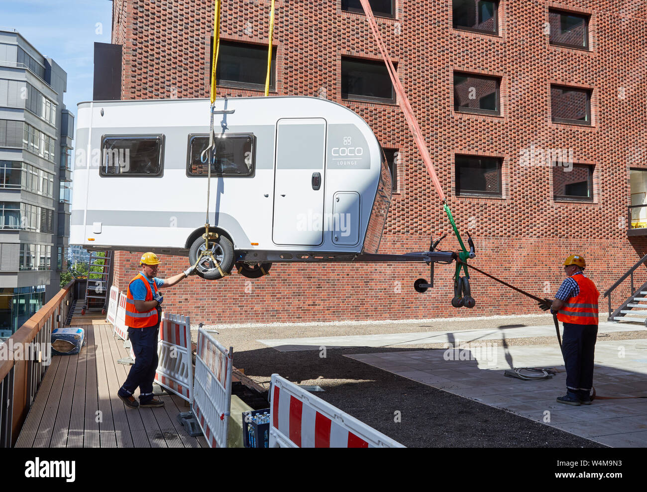 Hamburg, Germany. 24th July, 2019. A caravan is lifted by a crane onto ...