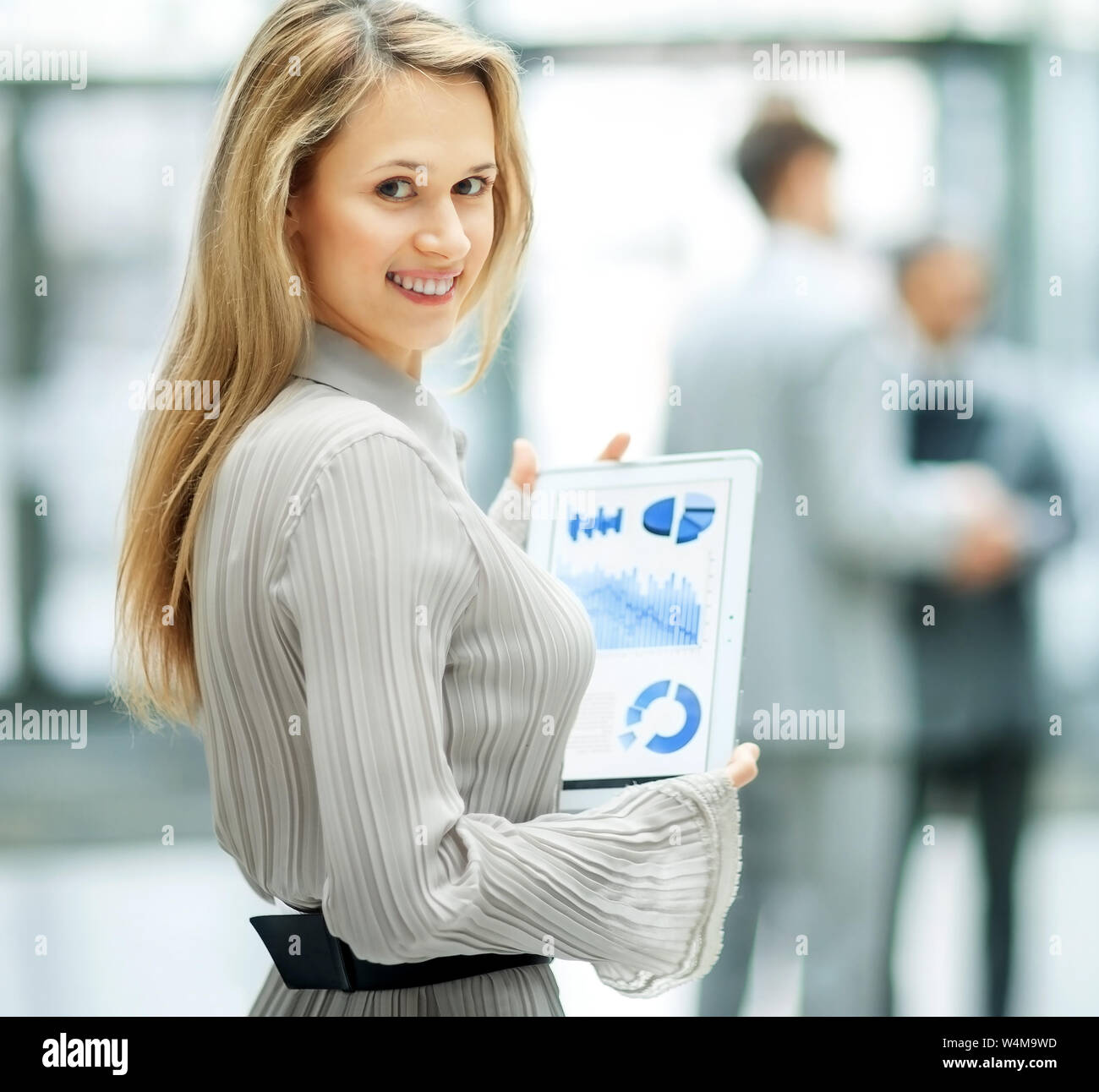 Successful business woman with the financial graph in the background in ...