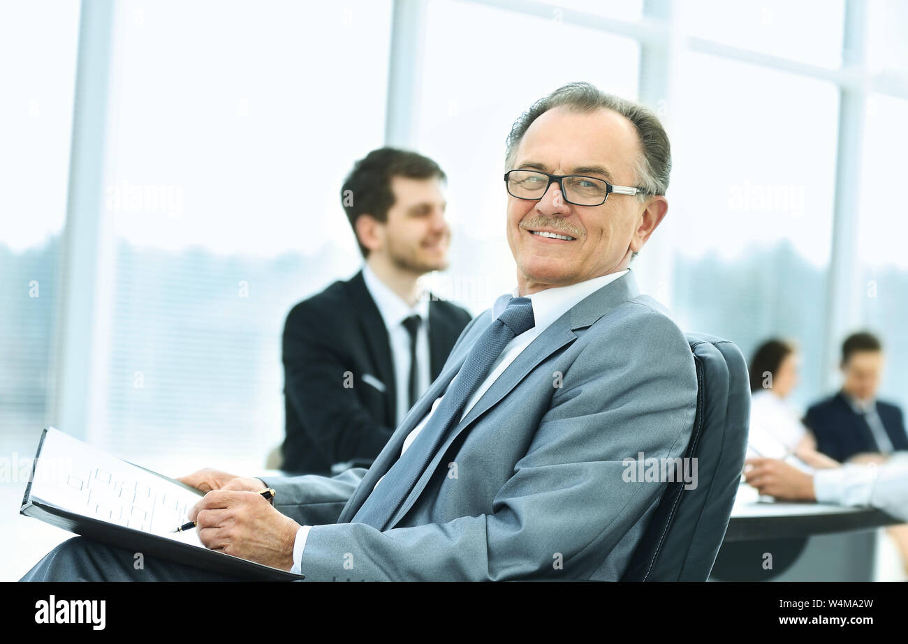 Portrait of a successful businessman in the office on the background ...