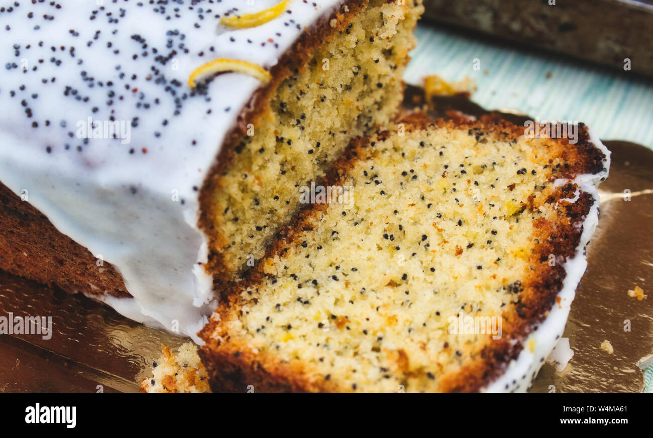 Poppy seed cade with slices of lemon and icing sugar Stock Photo - Alamy