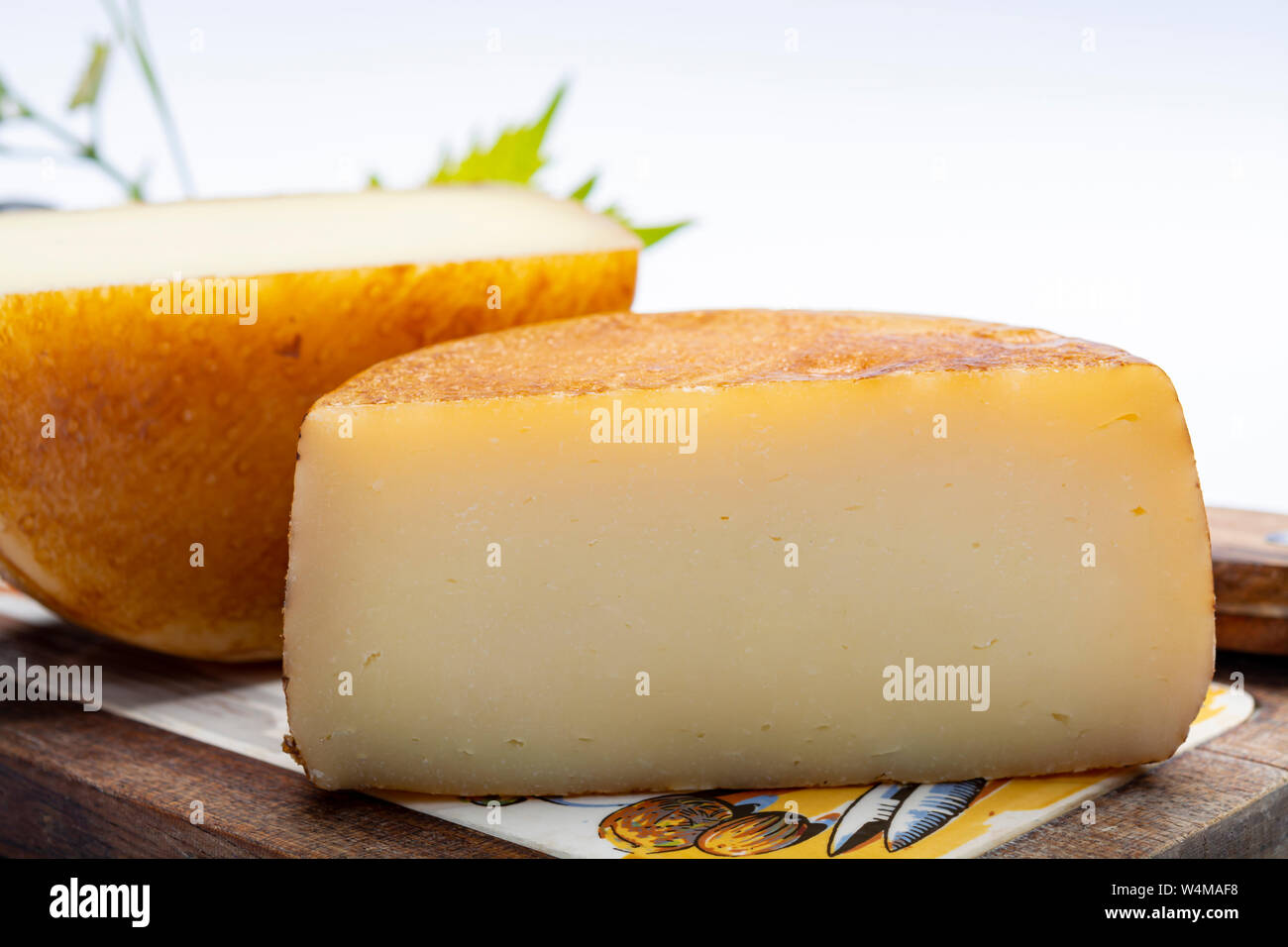 Hard Italian pecorino sheep cheese in two pieces close up isolated ...