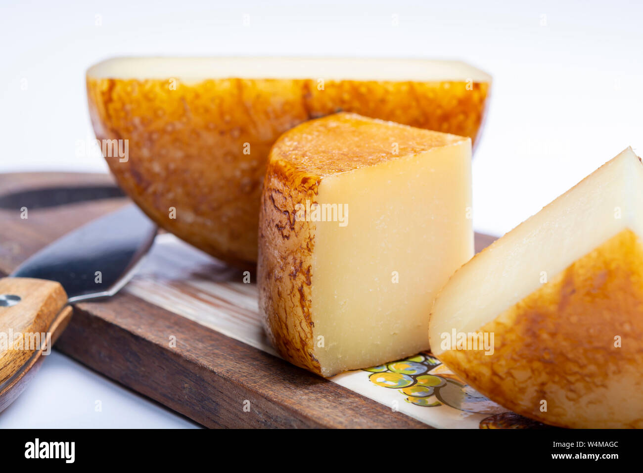 Hard Italian pecorino sheep cheese on wooden board close up isolated ...