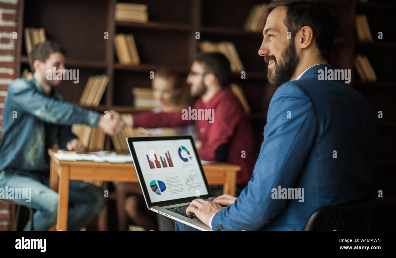 Manager Finance works with the marketing graphics on the laptop on the ...