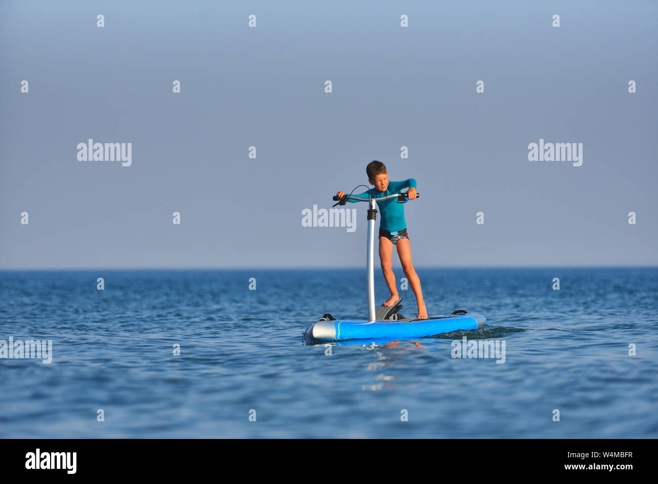 Happy active kid on a Hobie Stand Up Paddle board Stock Photo - Alamy