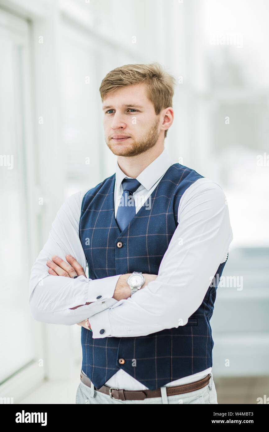 thoughtful beginner businessman standing near window with hands clasped ...
