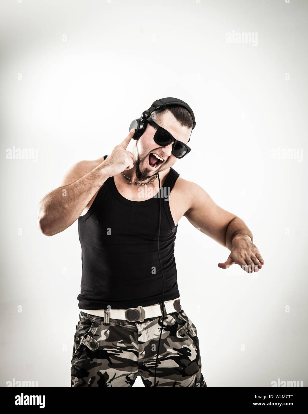 charismatic DJ - rapper with headphones on a white background.the photo ...