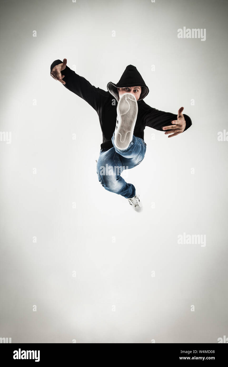 charismatic rapper is dancing breakdance .photo on a light background ...