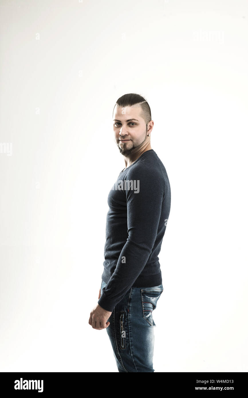 side view - the sports guy - a bodybuilder in jeans and a t-shirt on a ...