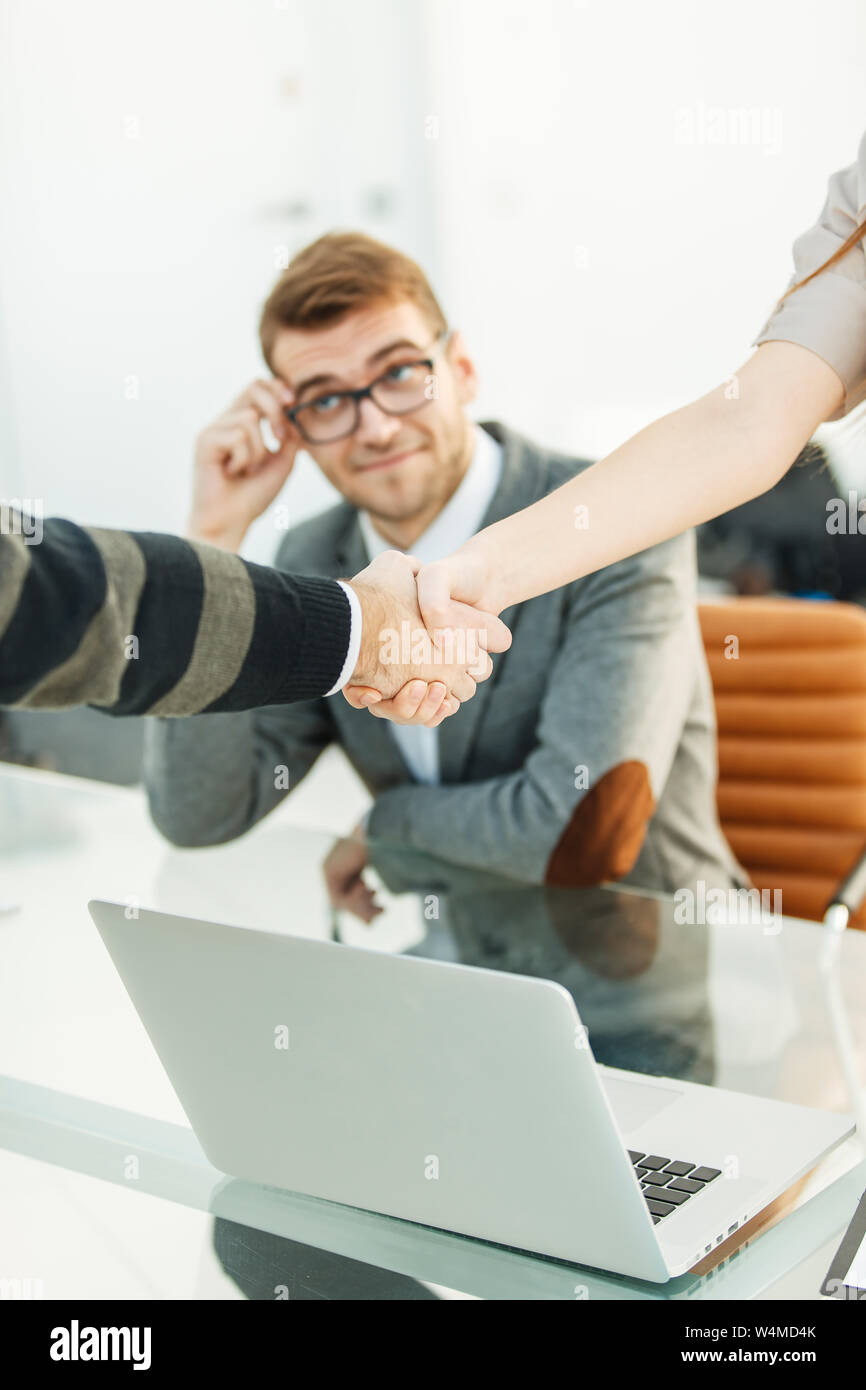 handshake of business partners on the background of the professional ...