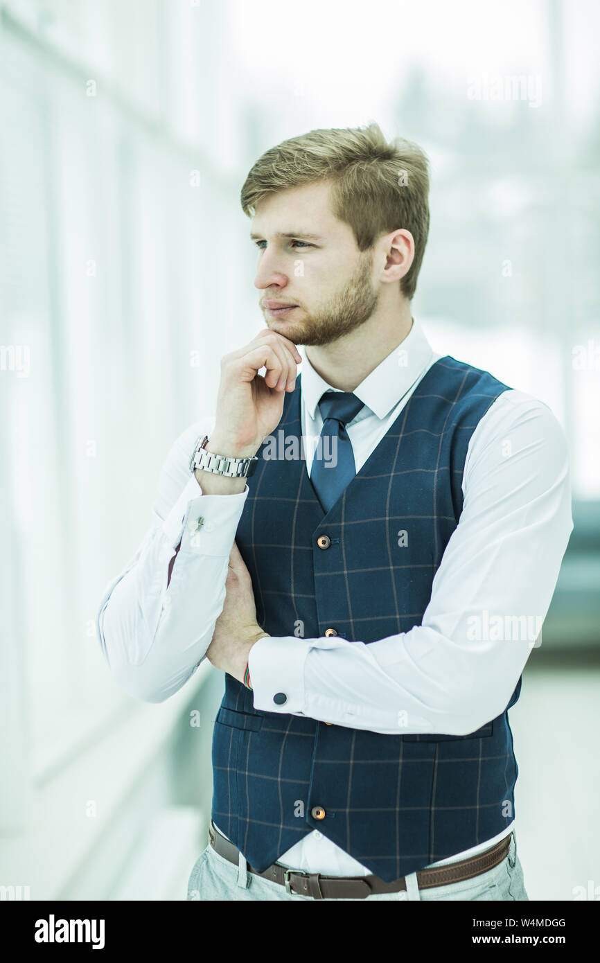 closeup of a thoughtful beginner businessman standing near the window ...