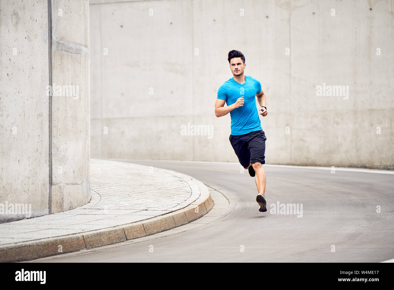 Picture of handsome man during jogging session in the city. Health and ...