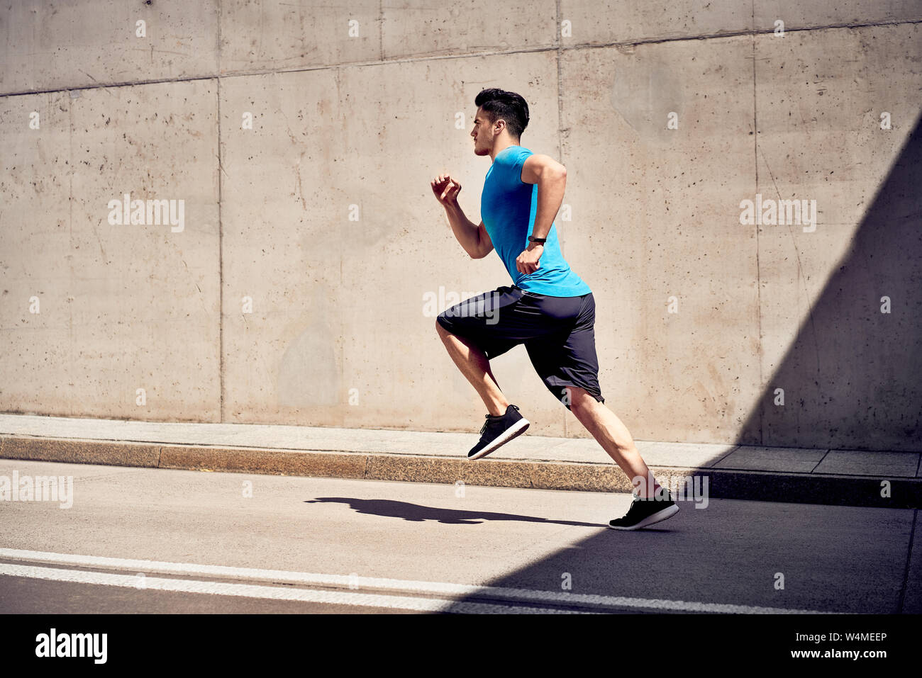 Man running on urban road hi-res stock photography and images - Alamy