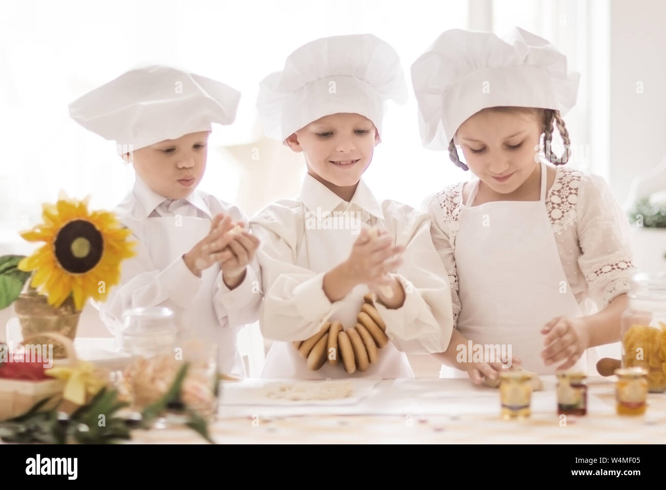 Happy little children in the shape of a chef to prepare tasty dishes in ...