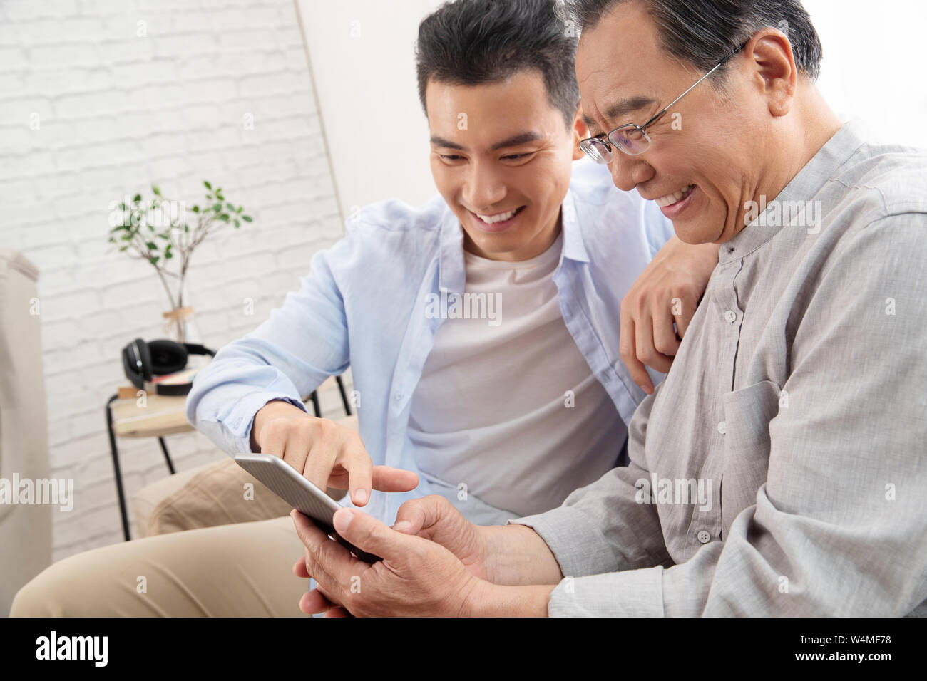 Happy father and son use cellular phones Stock Photo - Alamy