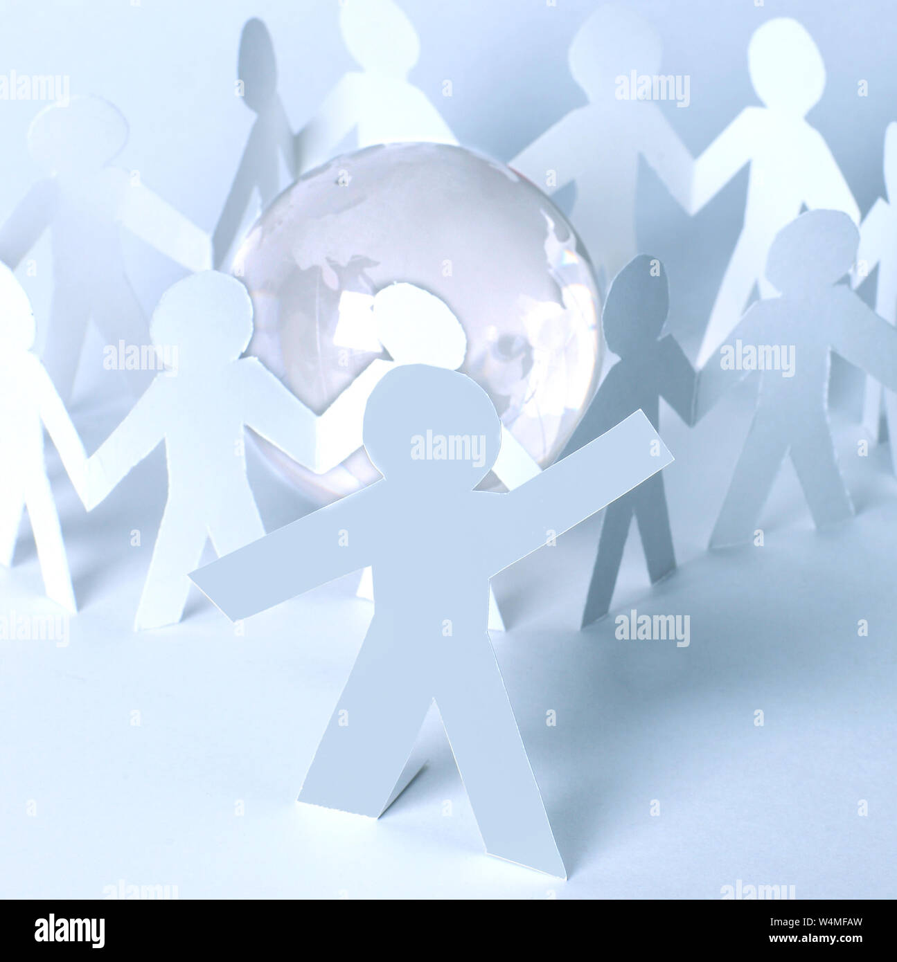 Paper man-leader against the background of paper people with a glass ...