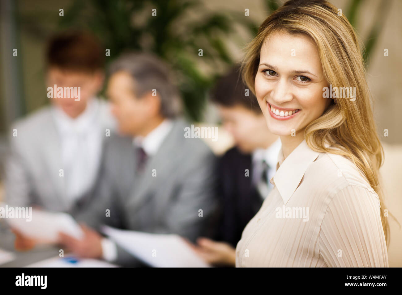 Portrait of a young confident business woman smiling Stock Photo - Alamy