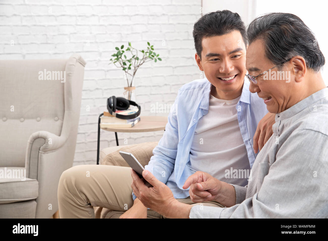Happy father and son use cellular phones Stock Photo - Alamy