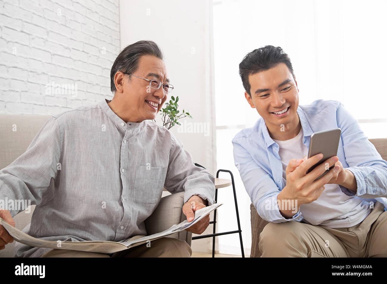 Happy father and son use cellular phones Stock Photo - Alamy