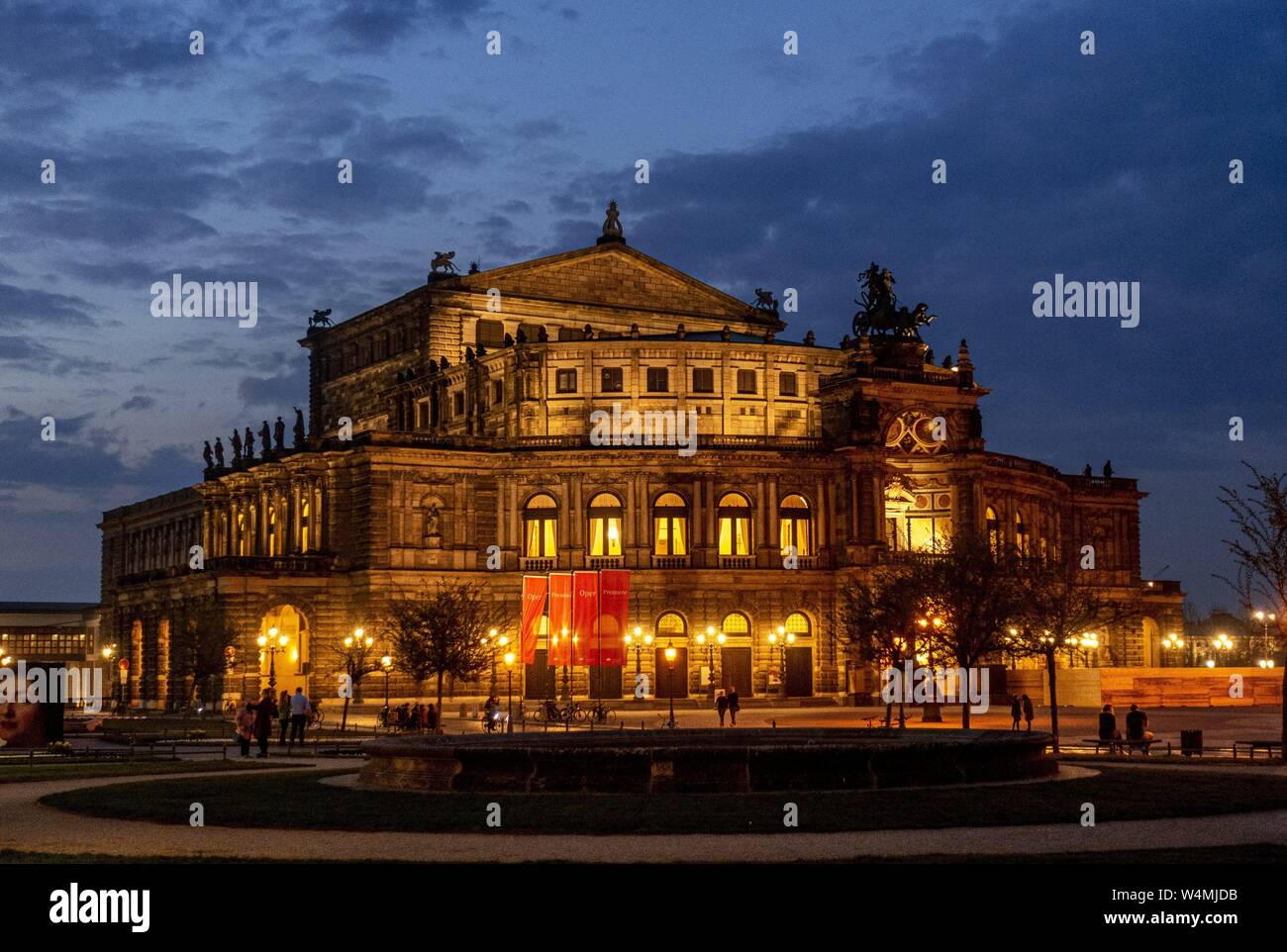 The illuminated Semper Opera at the Theaterplatz in Dresden. The ...