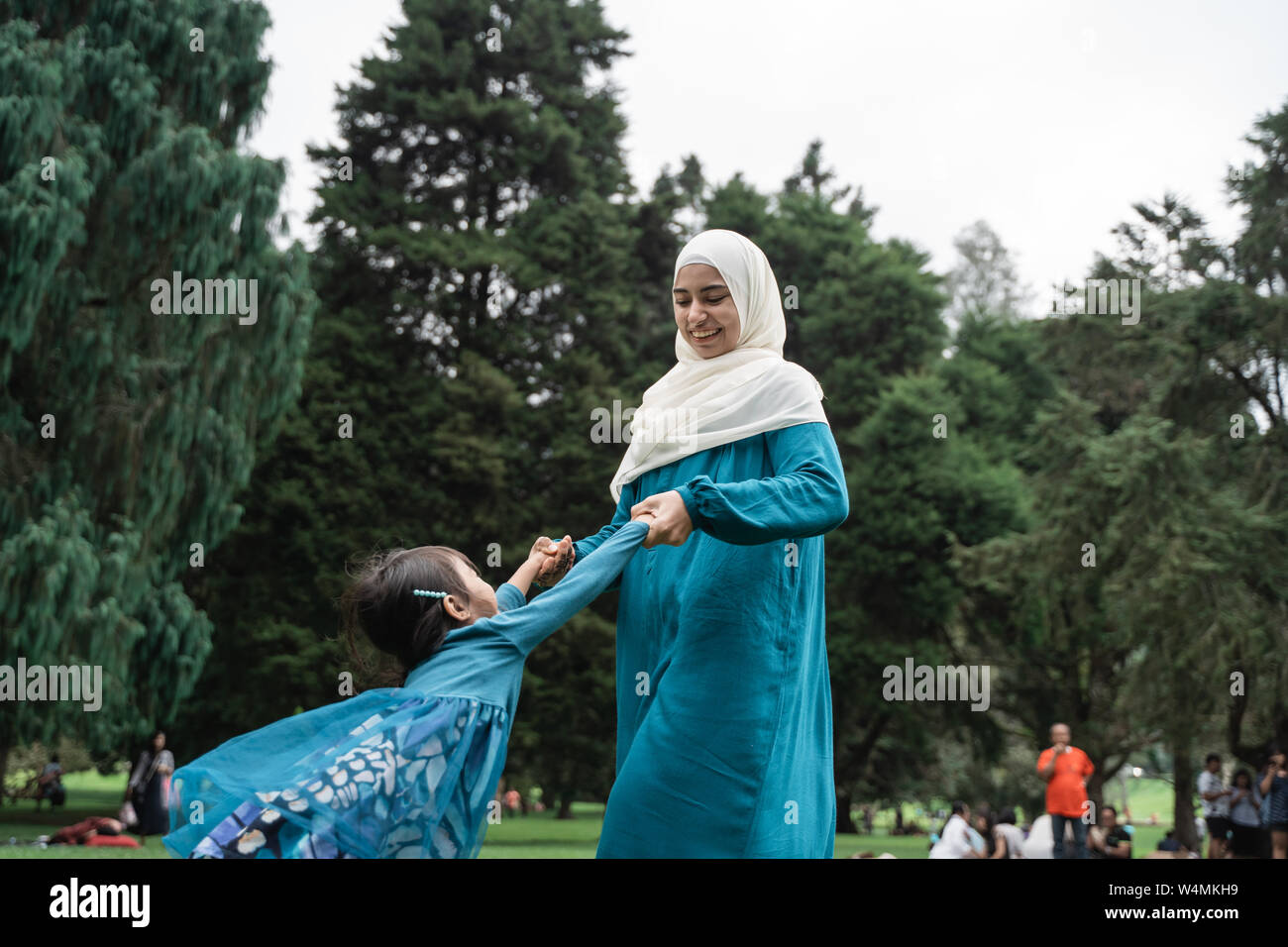 little girl playing spin around with mother Stock Photo - Alamy